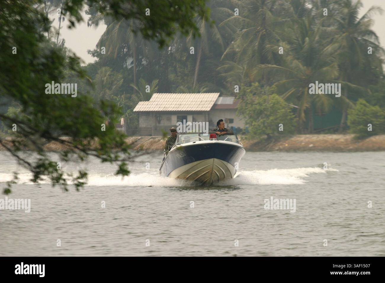 Apr 27, 2005; Tak Bai River, THAILAND; Thai marine officers conduct a ...