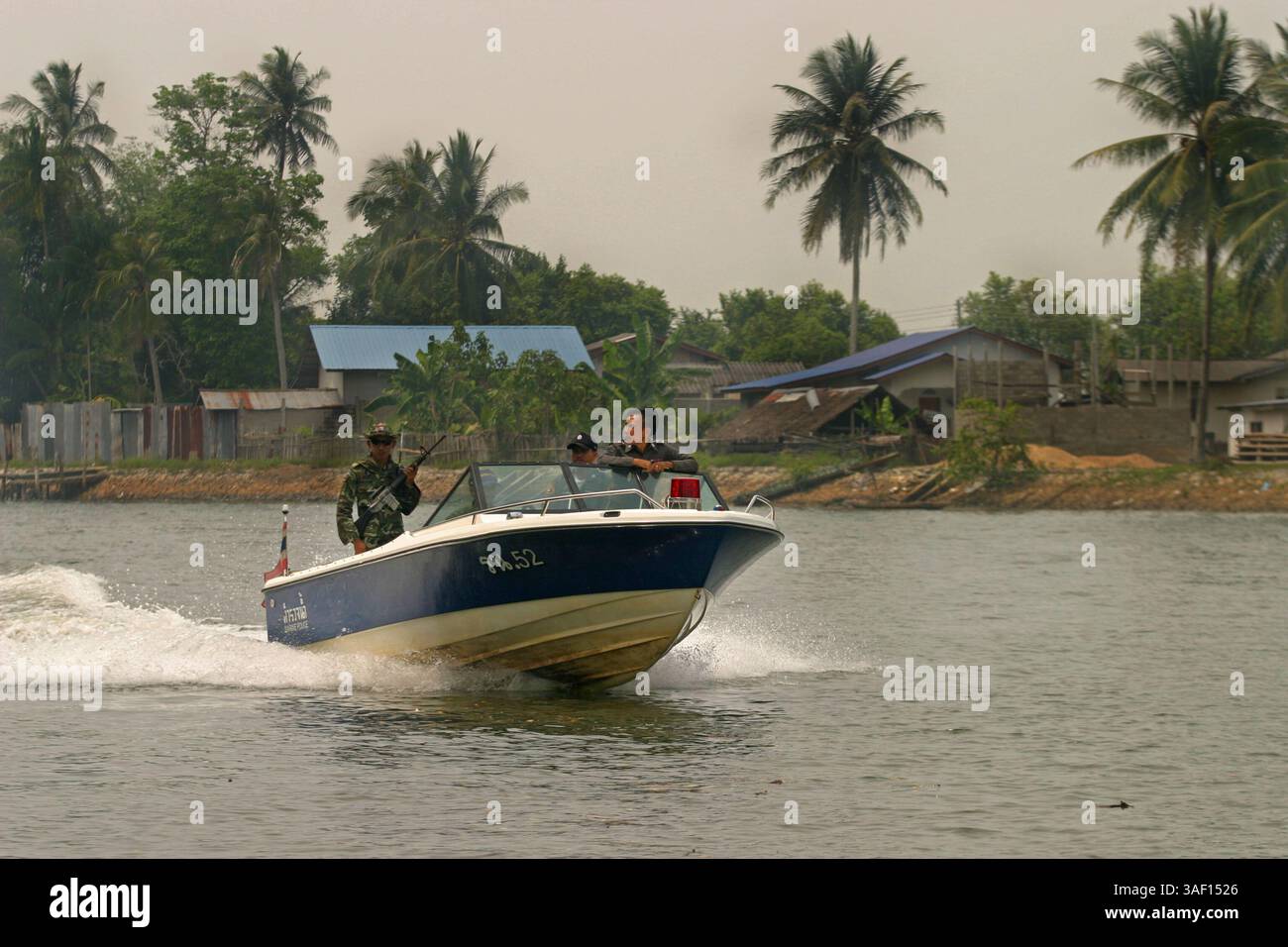 Apr 27, 2005; Tak Bai River, THAILAND; Thai marine officers conduct a ...