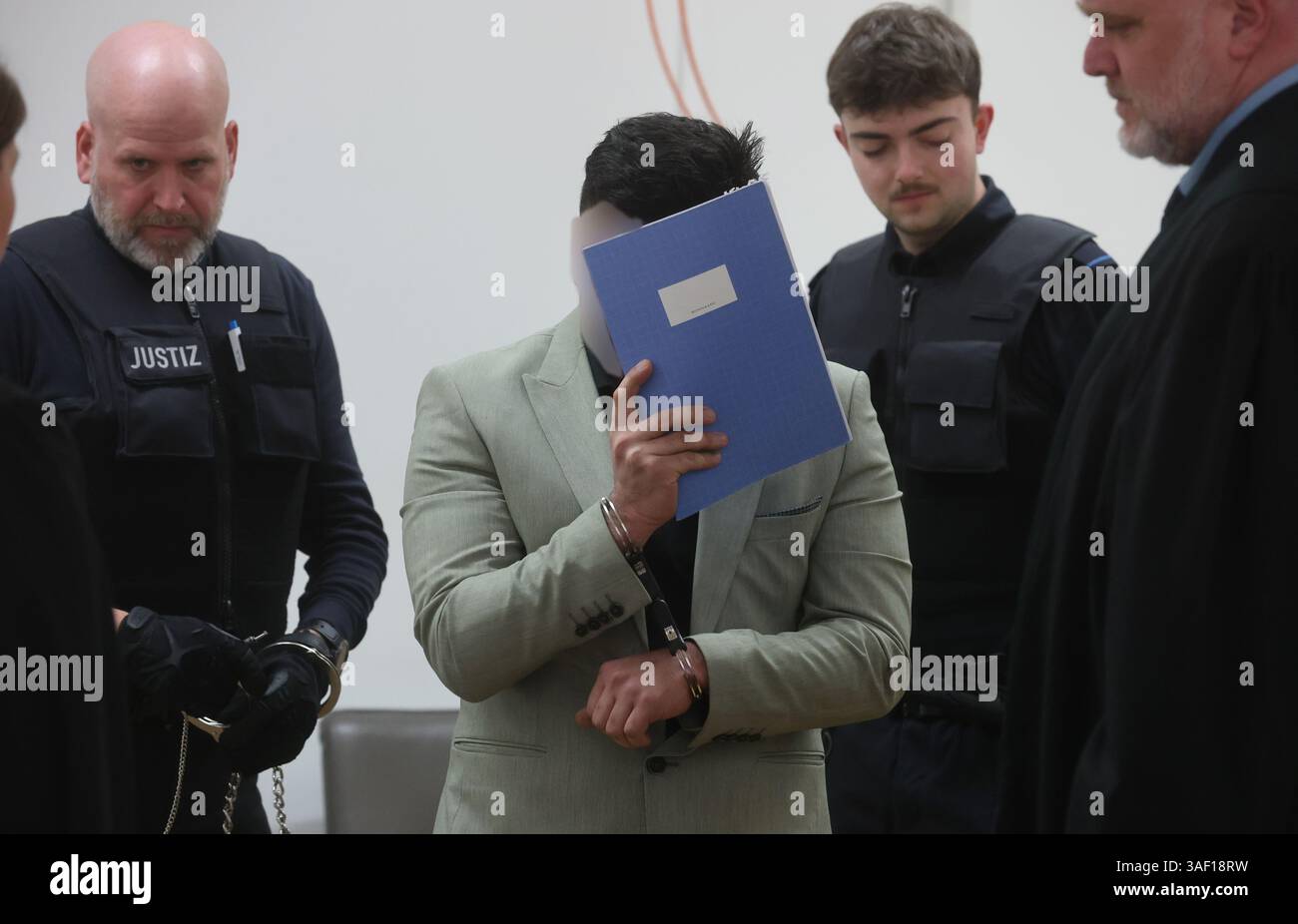 Gera, Germany. 07th Apr, 2025. The defendant is led into the courtroom ...
