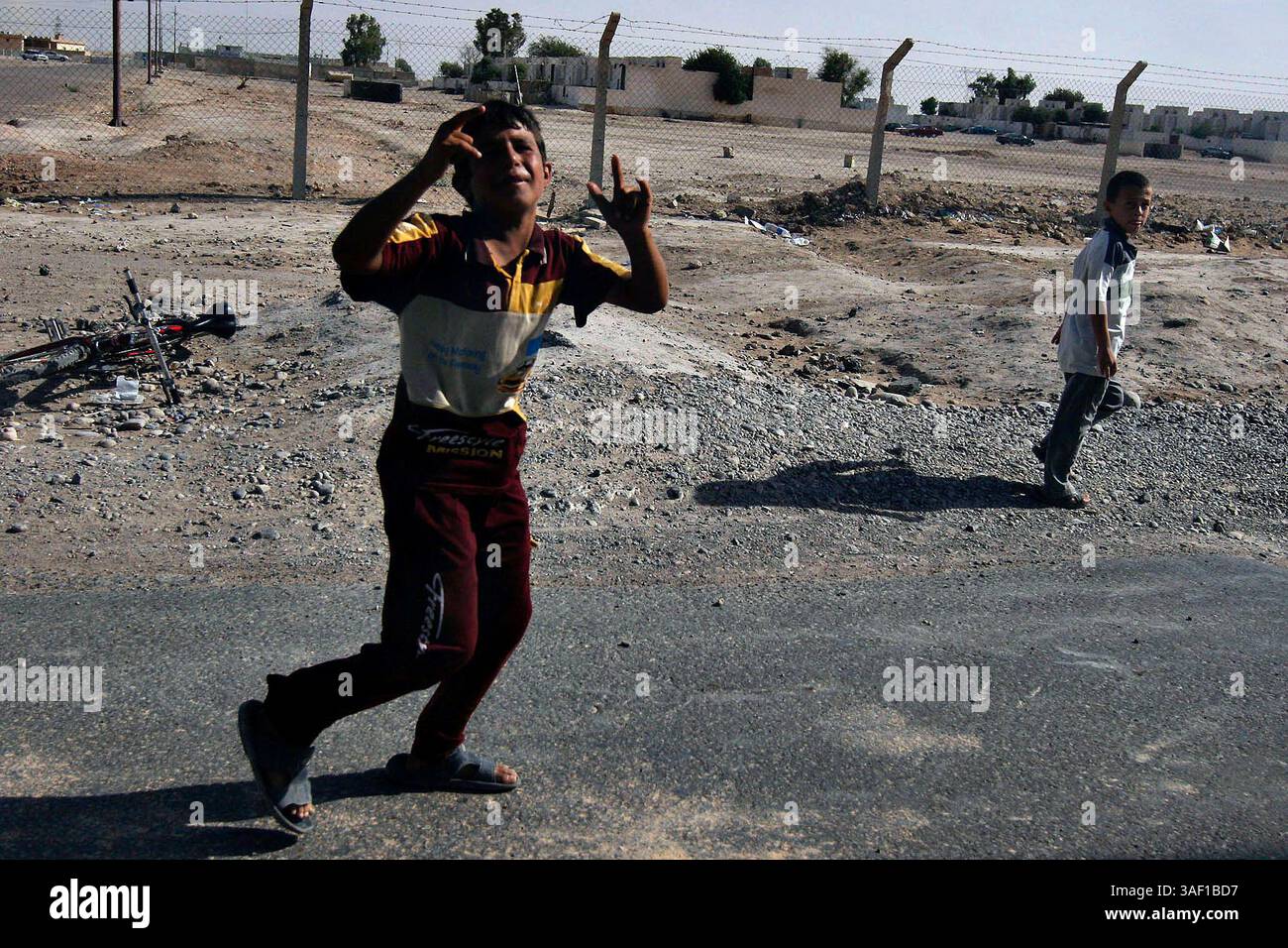 Sep 27, 2005; Tikrit, IRAQ; An Iraqi boy flashes the University of ...