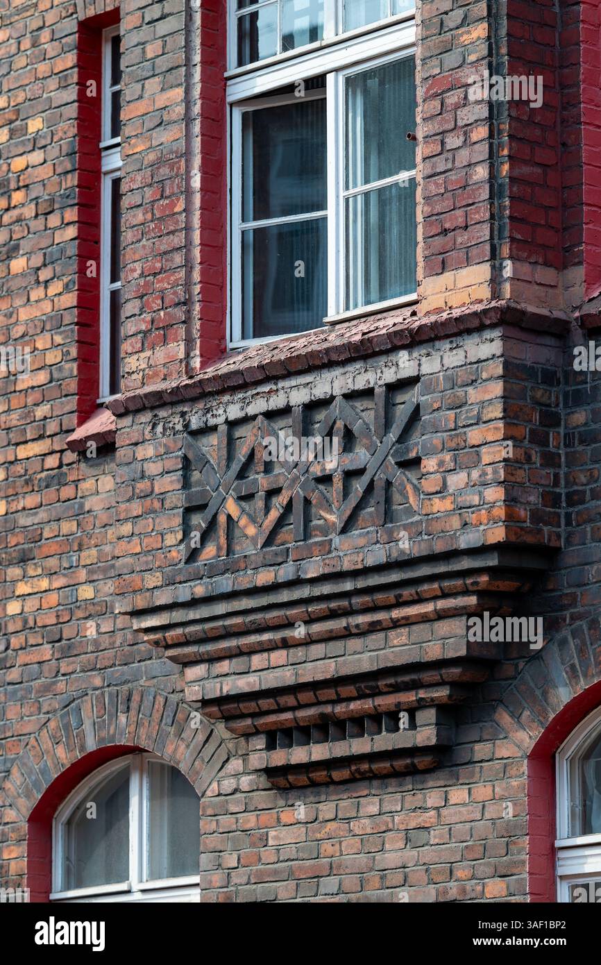 Brick facade of a tenement house in a workers' housing estate ...