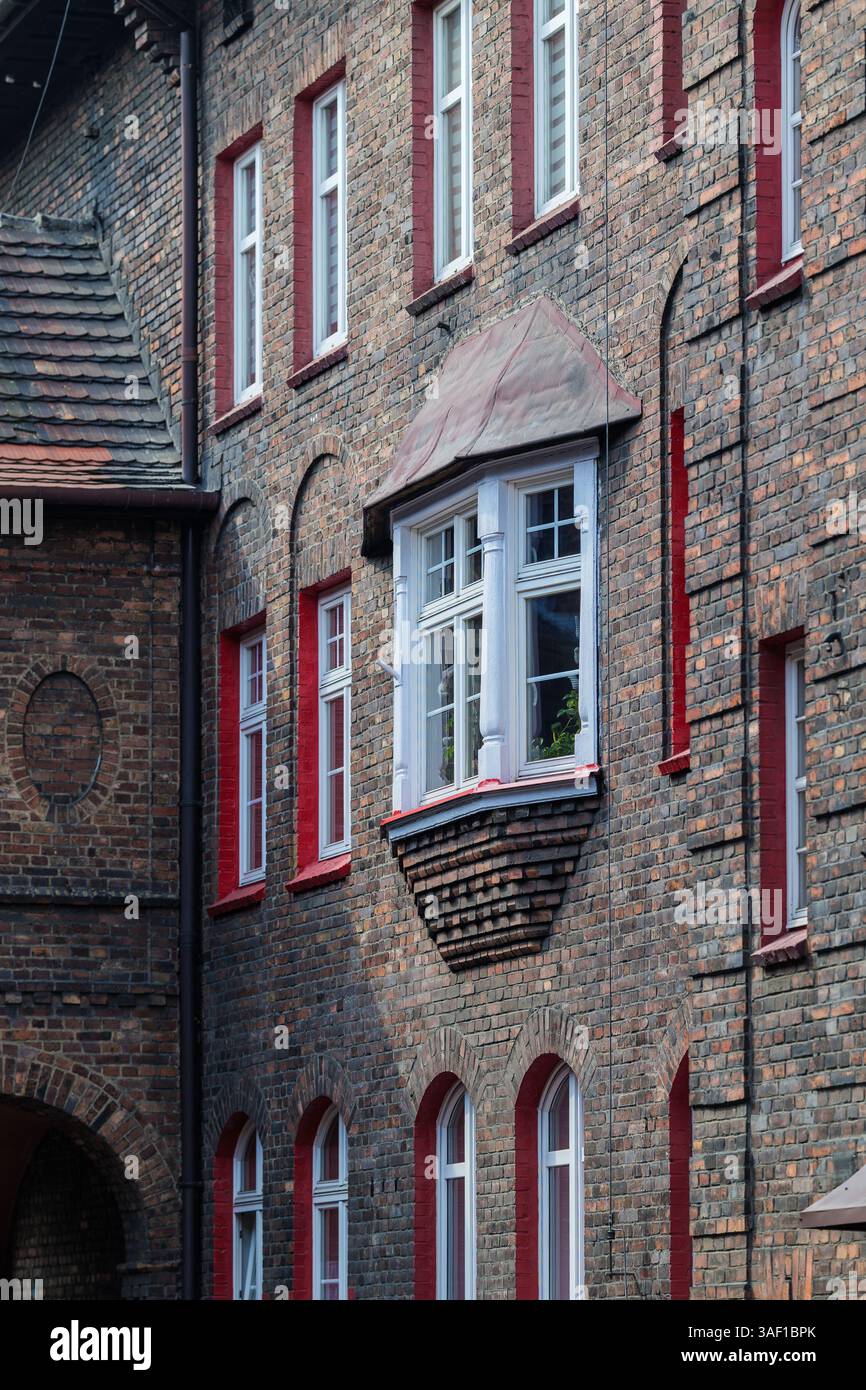Brick facade of a tenement house in a workers' housing estate ...