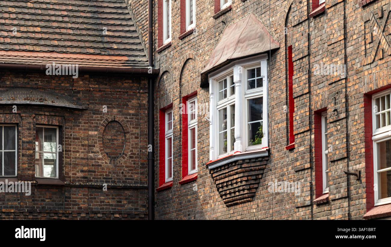 Brick facade of a tenement house in a workers' housing estate ...