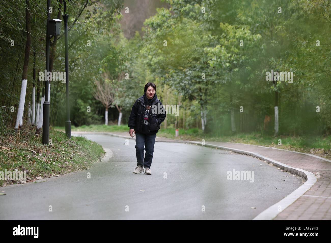 (250407) -- CHENGDU, April 7, 2025 (Xinhua) -- Giant panda keeper Li Rong walks on her way to ...