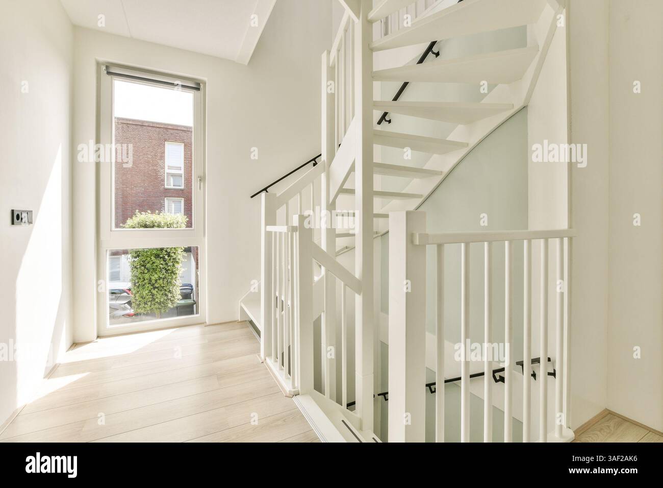 A bright, contemporary staircase in a well-lit interior featuring a ...