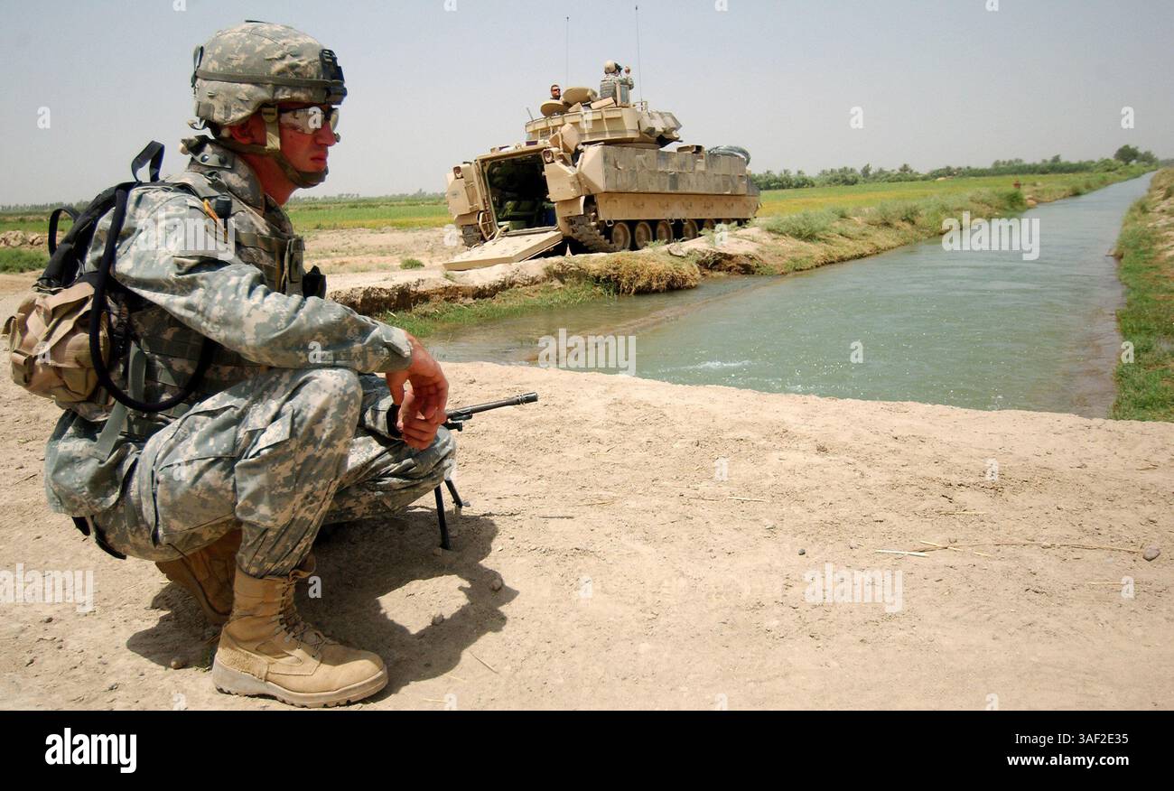 Jun 23, 2005; Al-Radwnea, Iraq; Army Spc. Eric Barrett watches for ...