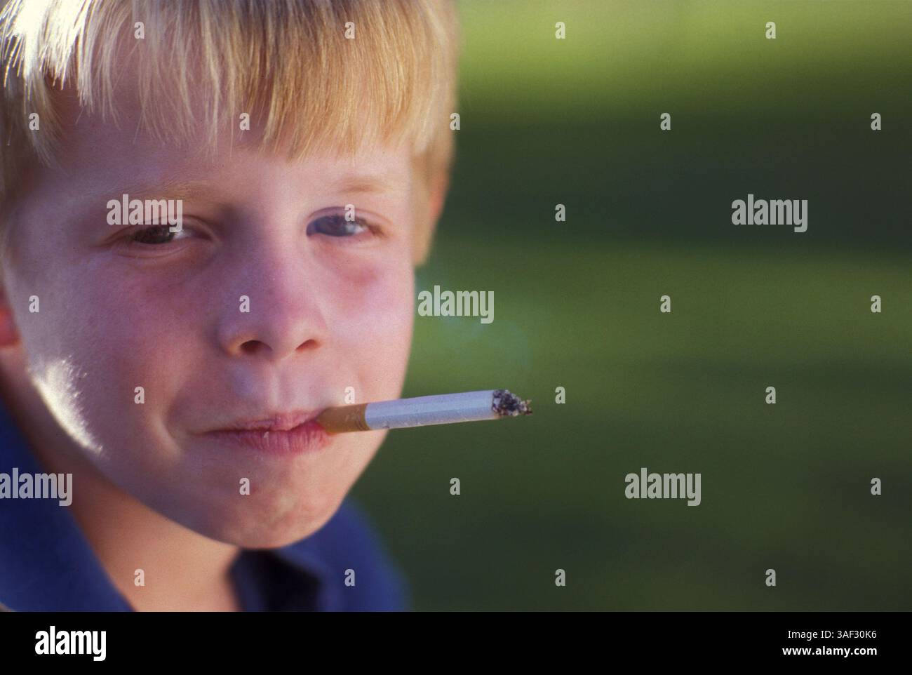 May 12, 1998; Los Angeles, CA, USA; A young boy smoking a cigarette ...