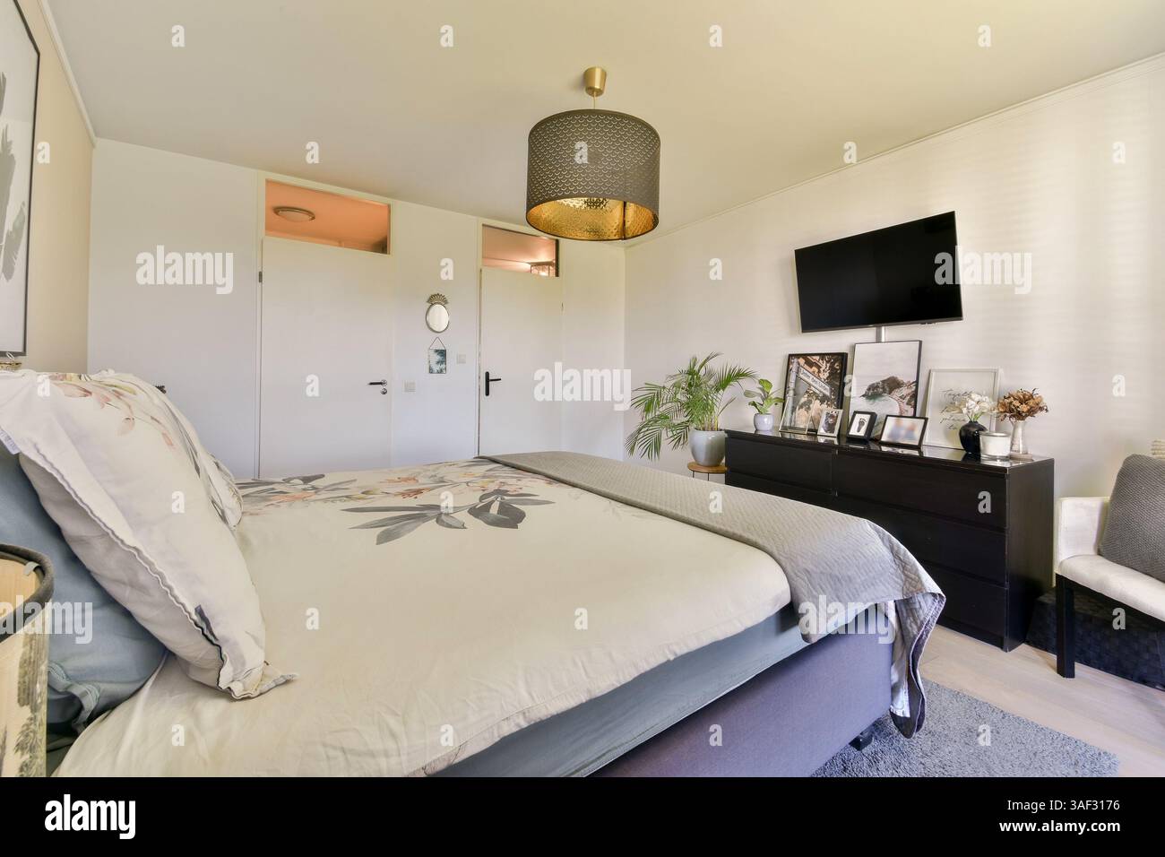 Cozy living room showcasing modern furniture, a stylish light fixture ...