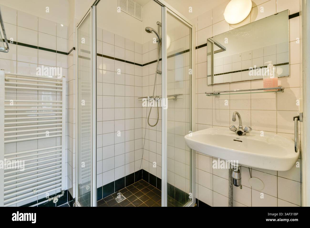 A sleek, modern bathroom showcasing a glass shower enclosure with a ...