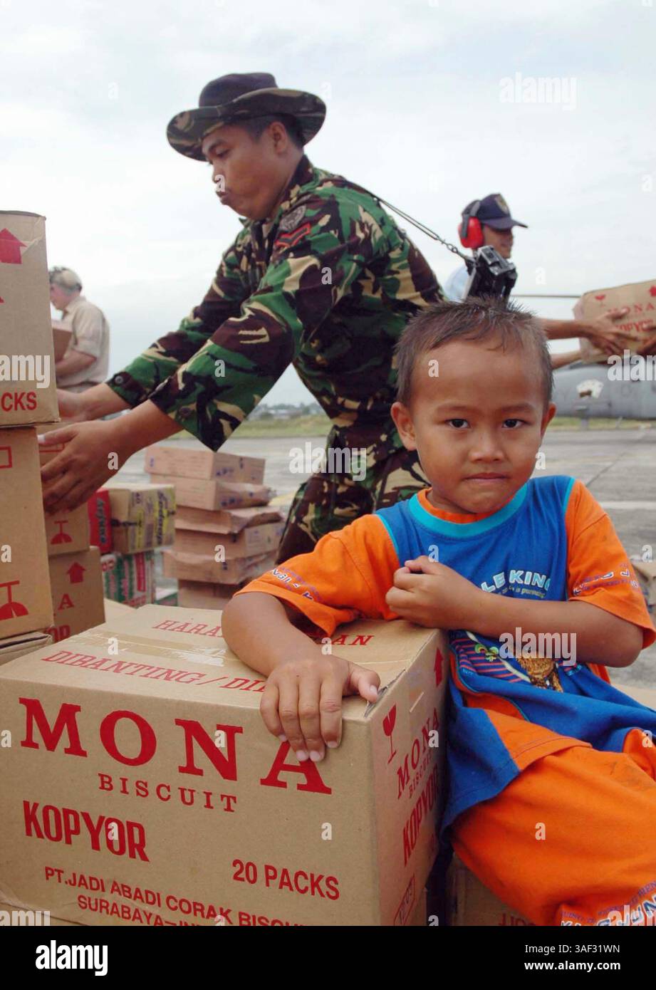 Jan 05, 2005; Aceh, Sumatra, INDONESIA; An Indonesian child leans against a box of supplies ...