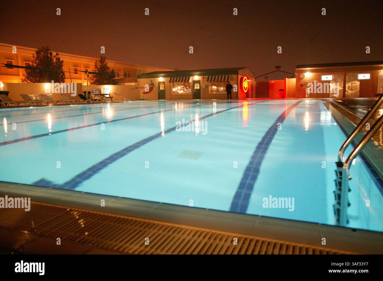 Dec 10, 2004; Camp As Sayliyah, Qatar; The long pool is quiet at night ...