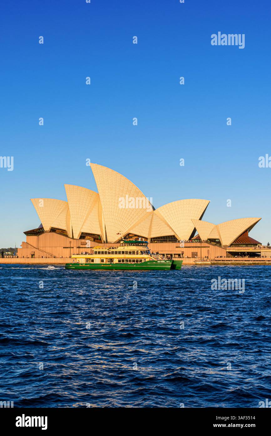 A Sydney ferry passes the Sydney Opera House on Bennelong Point, Sydney ...