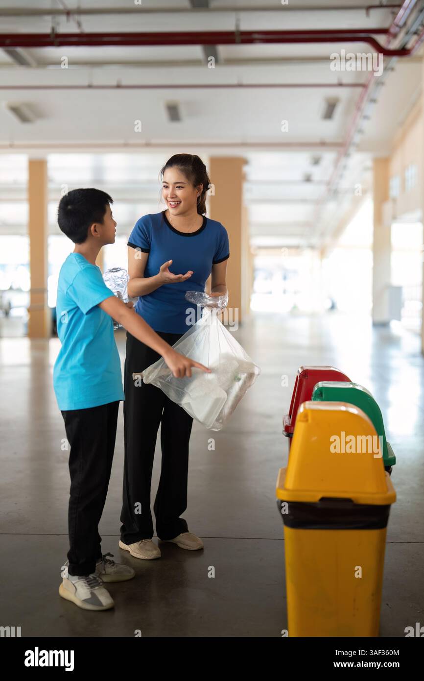 Waste Management and Family Bonding. Caregiver engages a child in ...