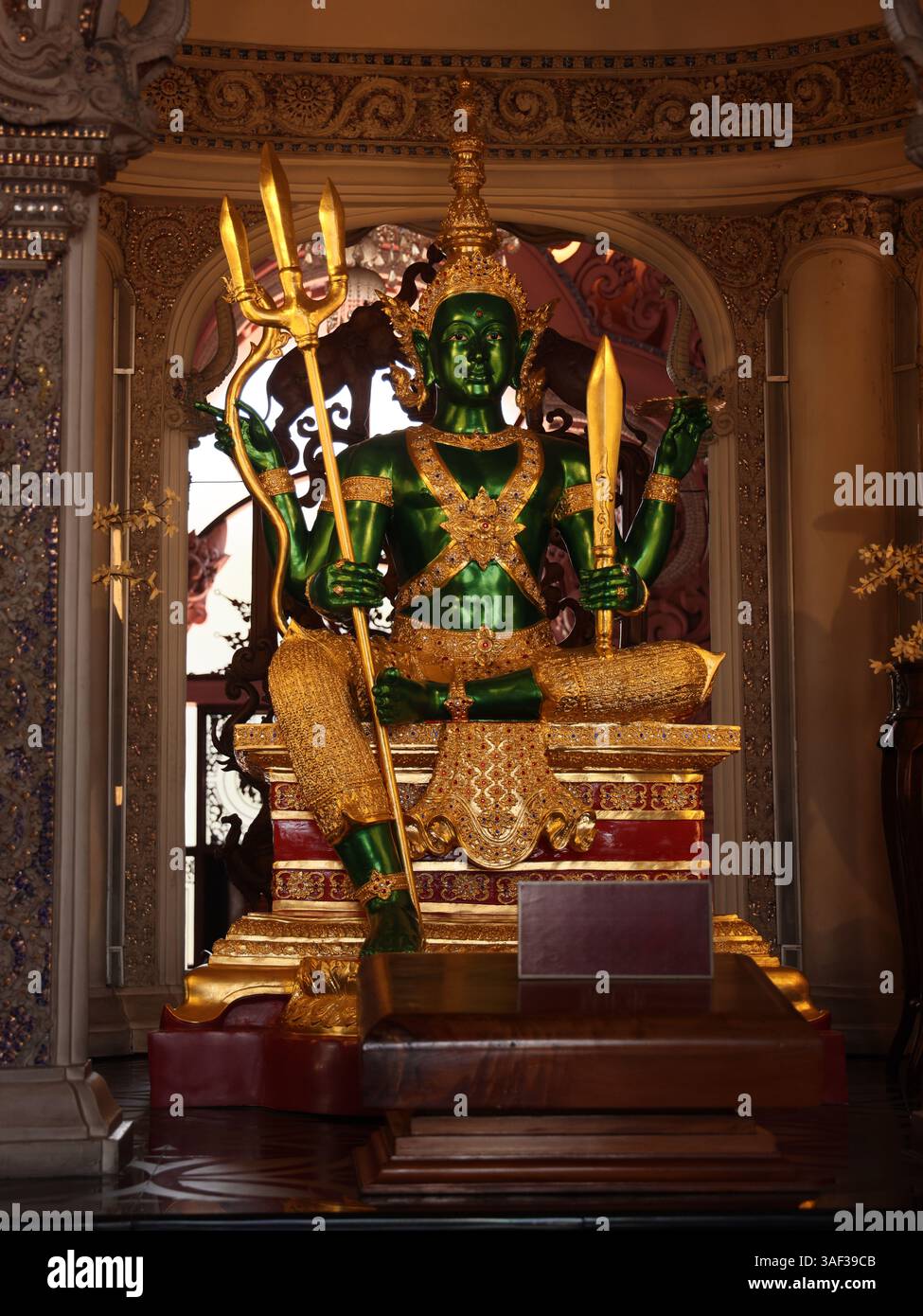 A Majestic Green Deity Statue elegantly adorned with Golden Accents in ...