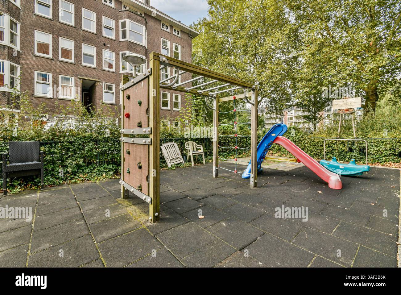 A vibrant children's playground featuring a climbing frame, slide, and ...
