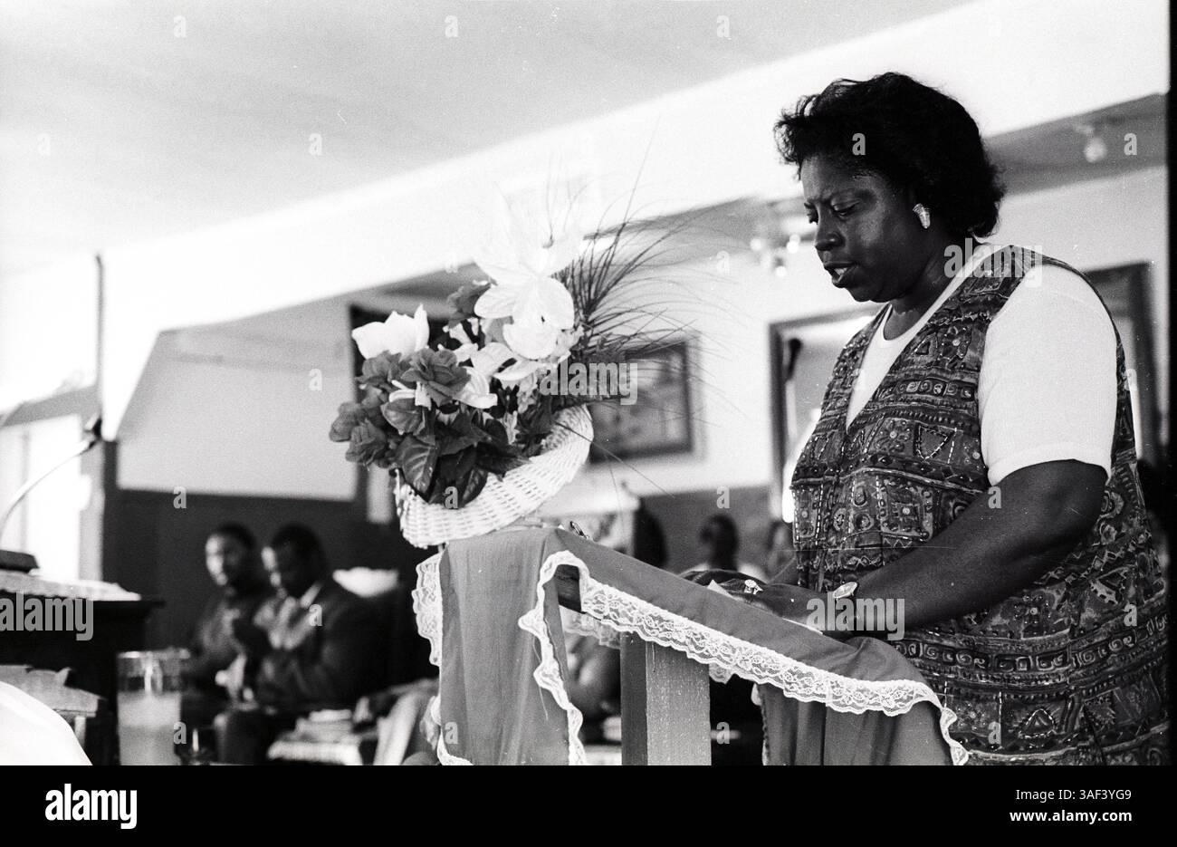 Woman of colour Giving Religious Speech at Podium in Community Setting ...