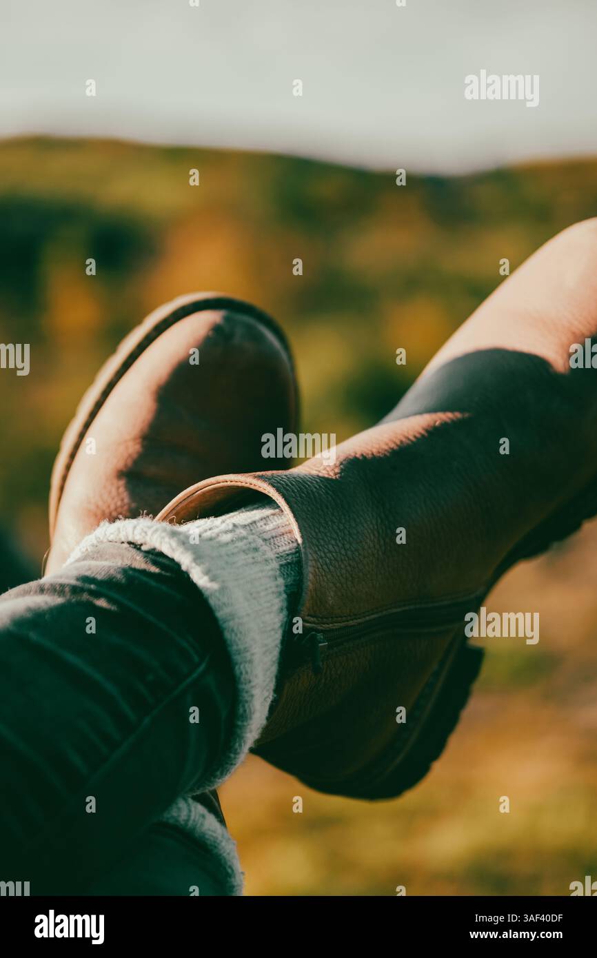 Relaxed person wearing boots in nature Stock Photo - Alamy