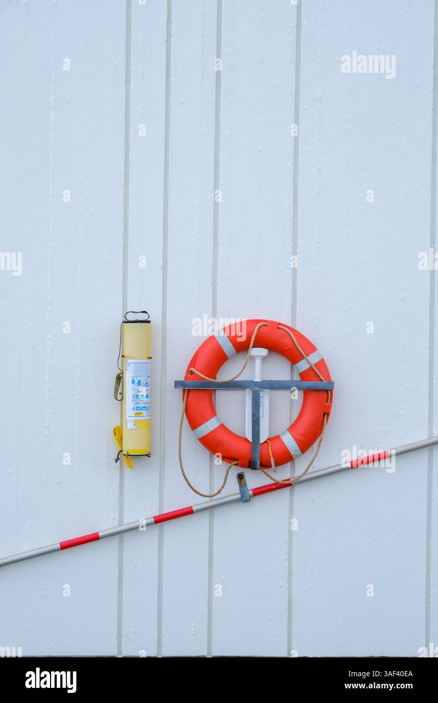 A red and white life preserver and a pole Stock Photo - Alamy