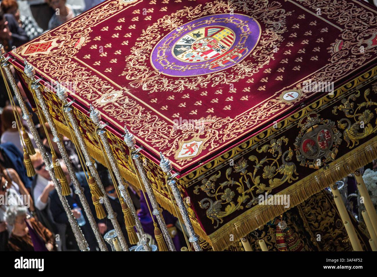 Crowds gather in Seville for Holy Week, admiring the ornate canopy of ...