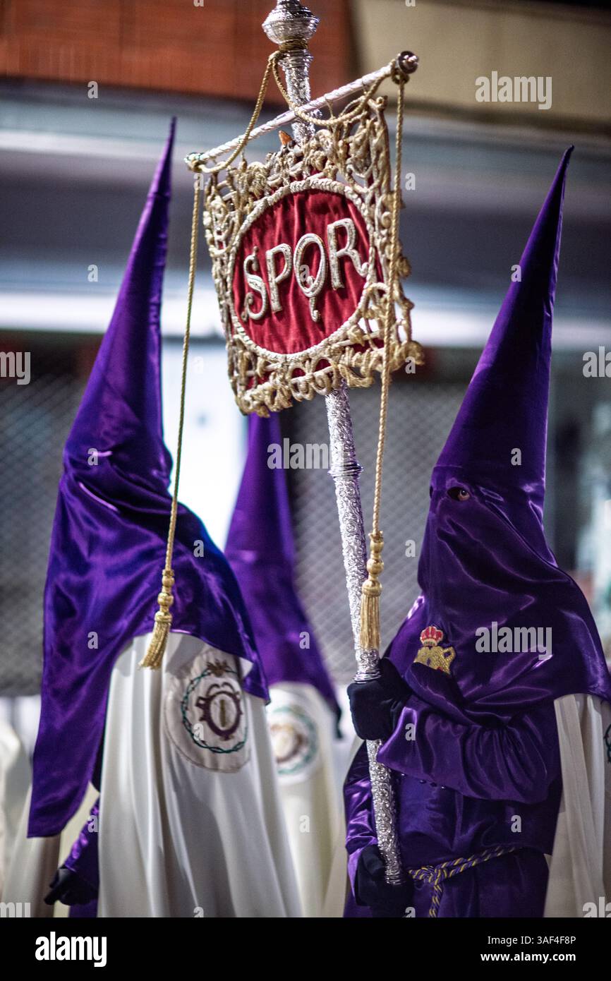 During Holy Week in Seville, a penitent carries the Roman Senatus ...