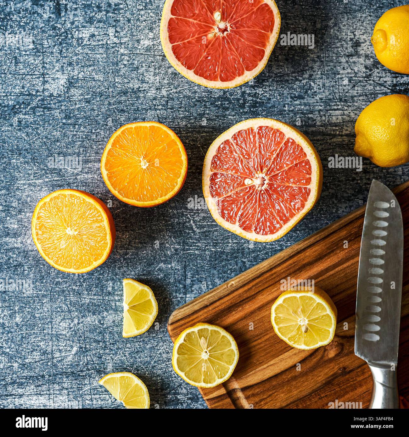 Citrus Fruit slices on a countertop with cutting board and knife Stock ...