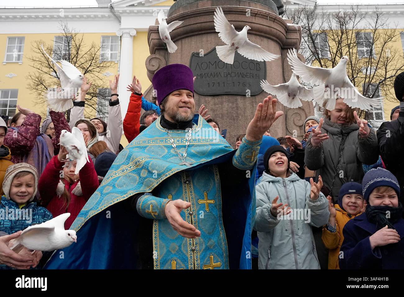 Orthodox priest Father Igor, center, with children and their parents ...