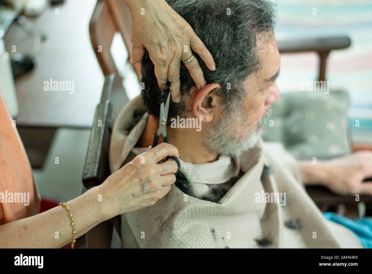Senior Man getting haircut from Senior wife at home Stock Photo - Alamy