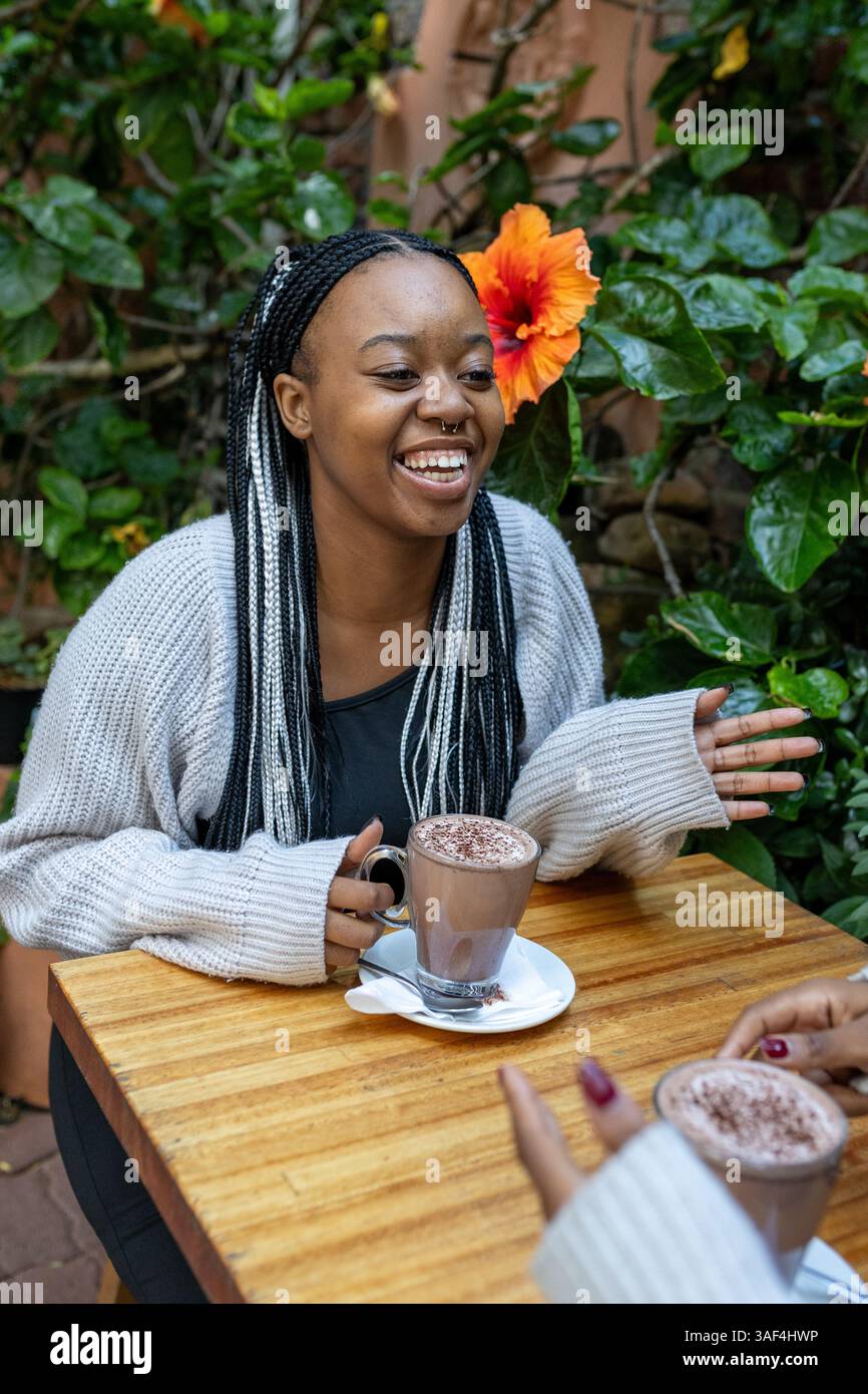 Black female drinking hot chocolate telling a story talking Stock Photo ...