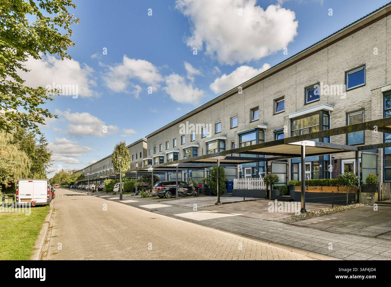 A contemporary urban residential building featuring large windows, a ...