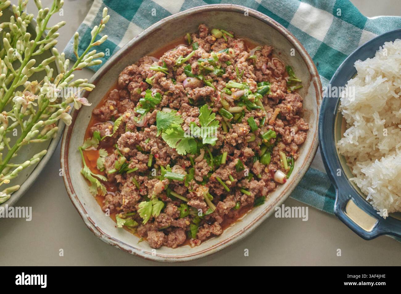 Authentic Thai Larb with Sticky Rice and Edible Flowers Stock Photo - Alamy