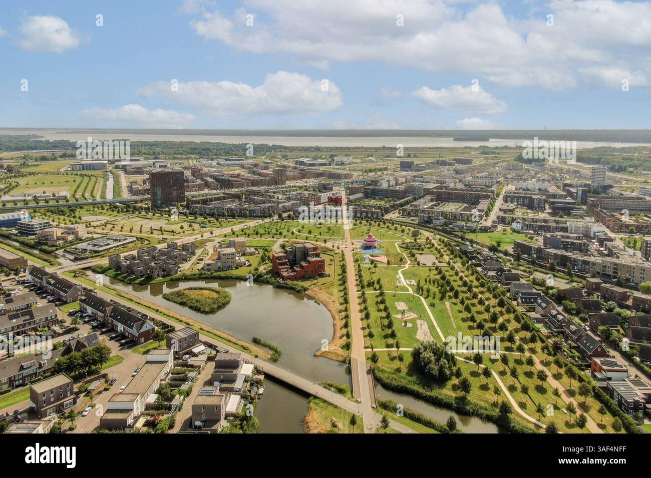 The image showcases a sprawling urban area featuring parks, pathways ...