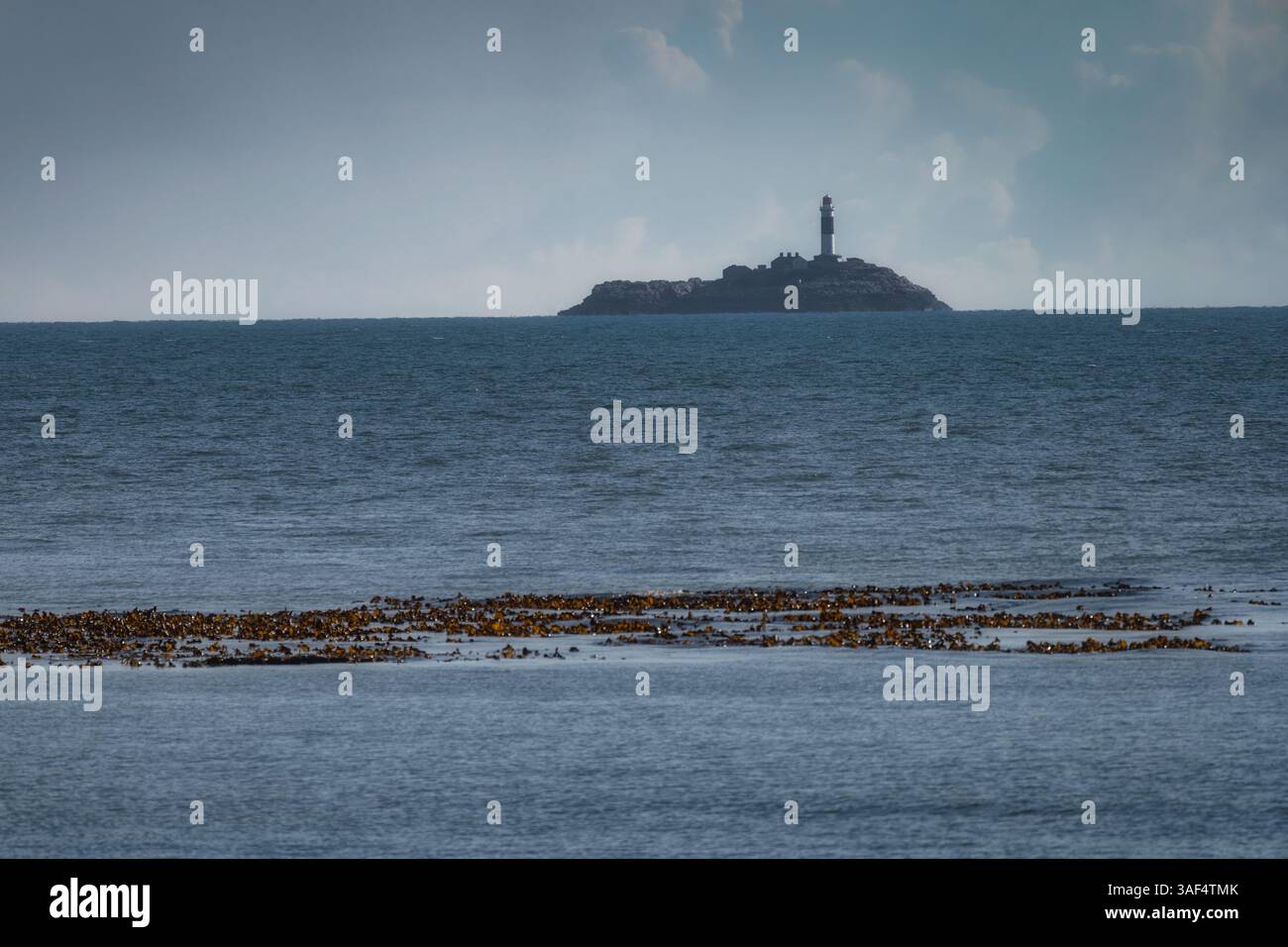 A tall, majestic Rockabill Lighthouse stands proudly on a secluded ...