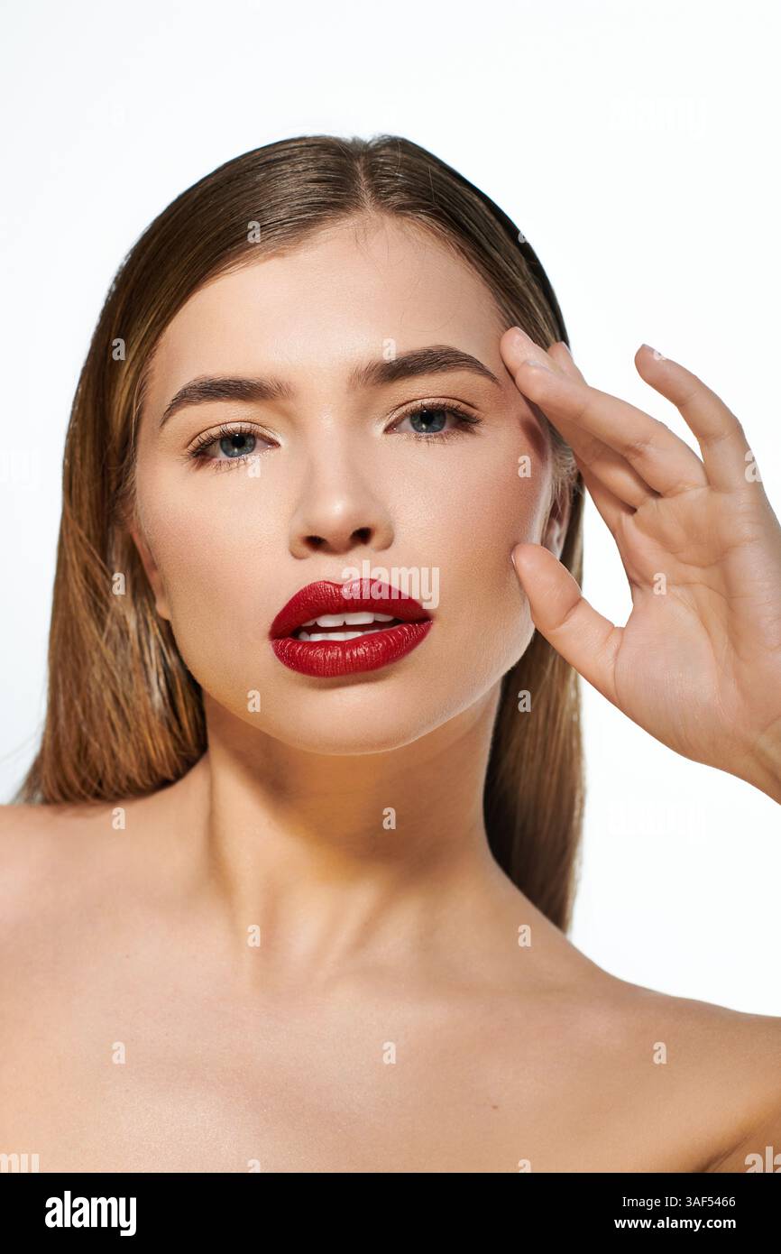 In a captivating setting, a young woman showcases her beauty with bold ...