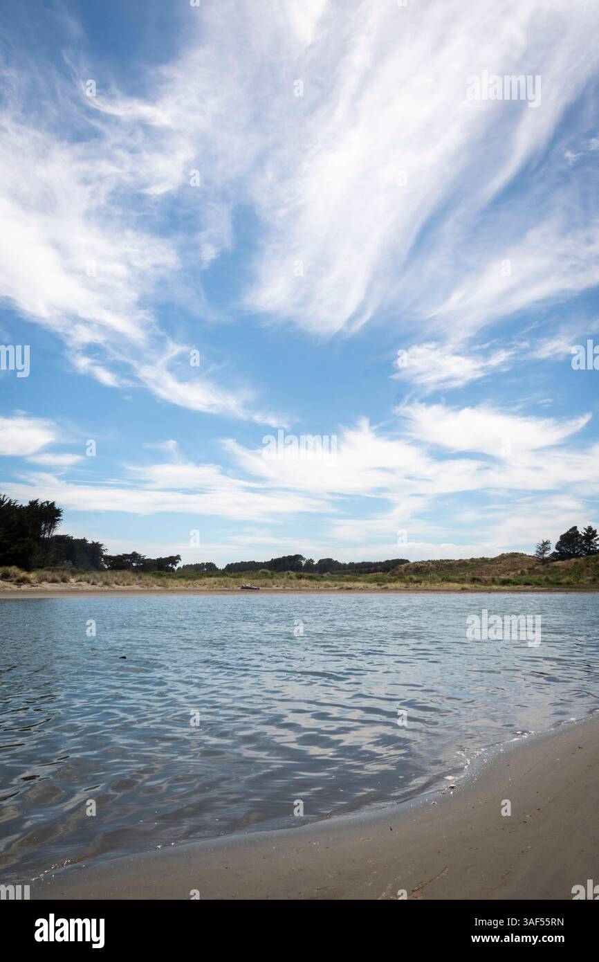 White cloud patterns above river estuary, Kuku Beach, Horowhenua, North ...