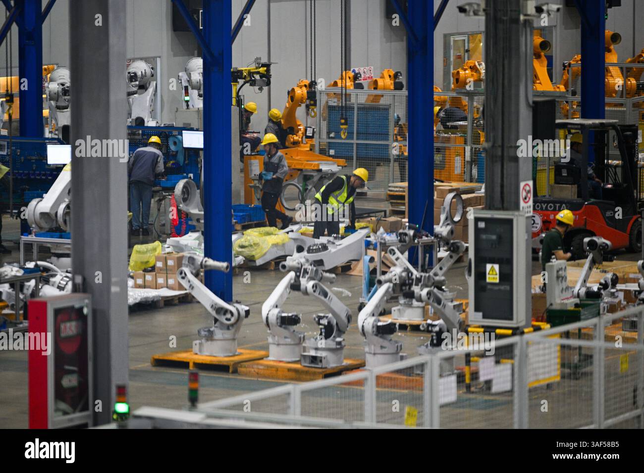 NANJING, CHINA - APRIL 7, 2025 - A worker assembles industrial robots ...
