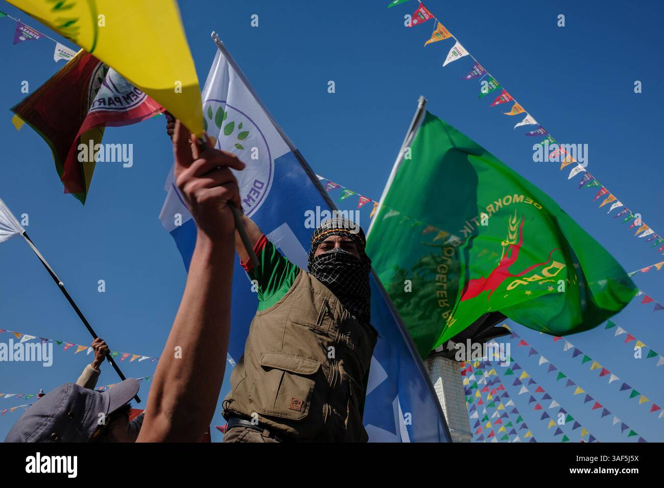 A young man waves the Peoples' Equality and Democracy Party (DEM Party ...