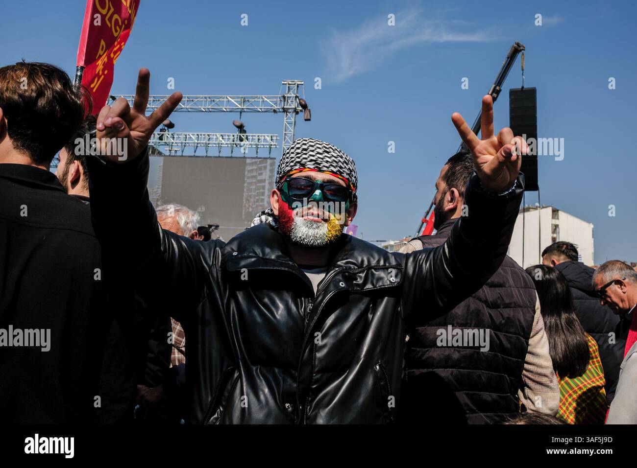 A man paints the colors of the Iraqi Kurdish Regional Government flag ...