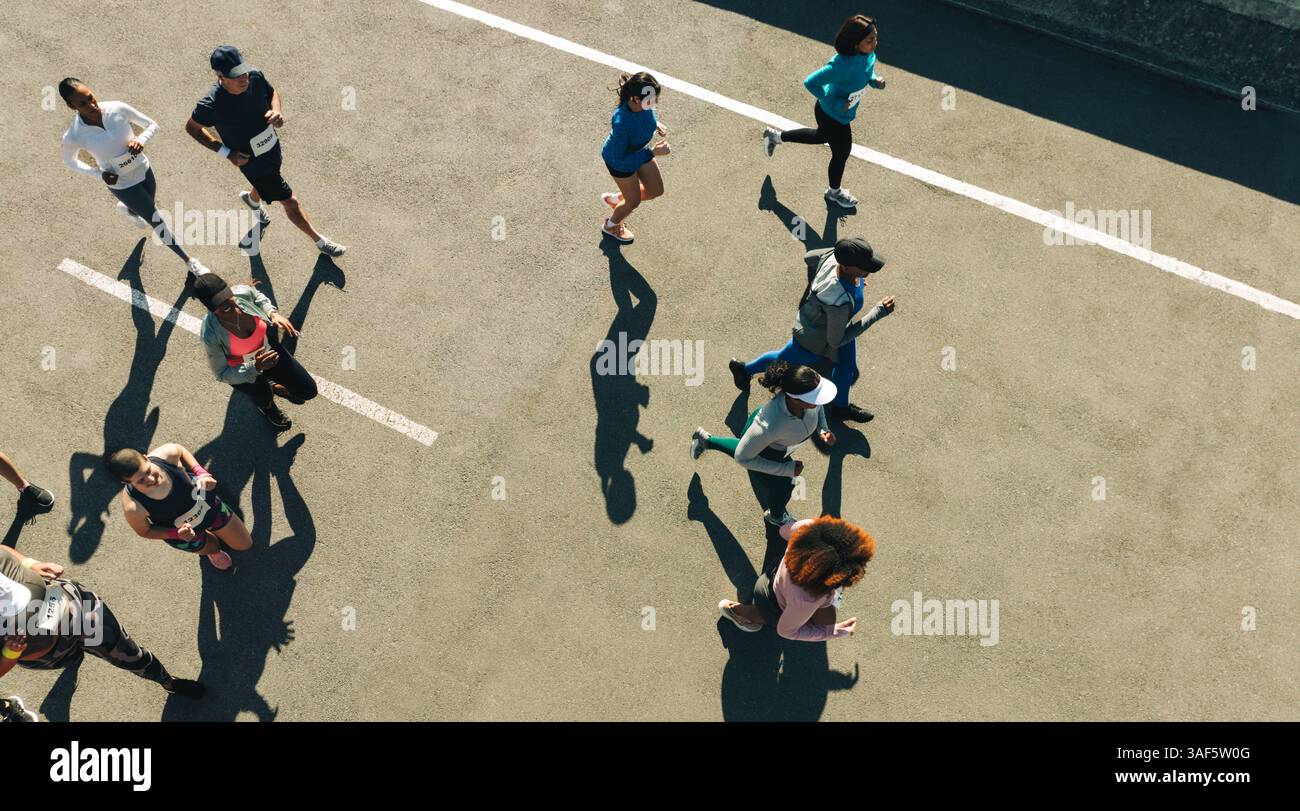 A diverse group of people participate in an outdoor race, showcasing ...