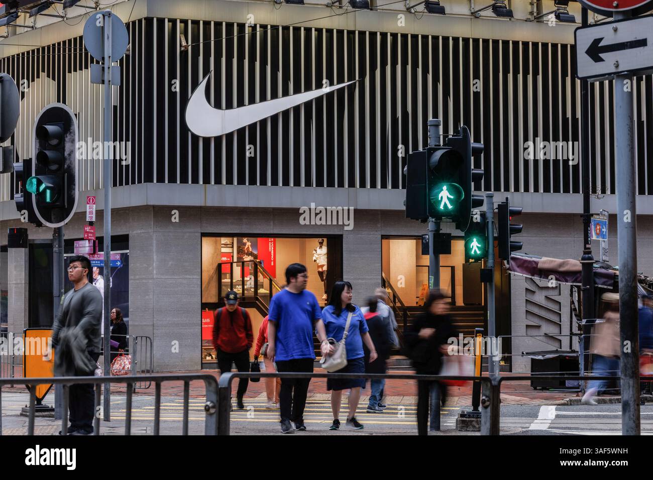 People walk pass Nike's store in Hong Kong. Nike, one of the world's biggest sportswear brands ...