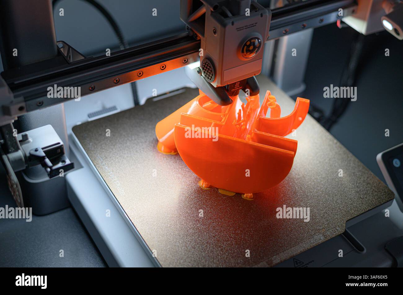 3D Printer Creating Detailed Orange Model On Platform Stock Photo - Alamy