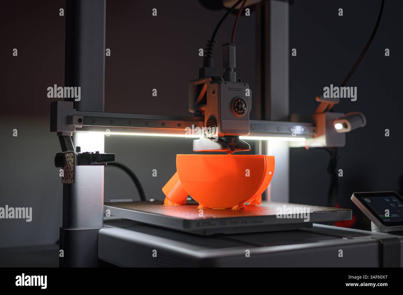 3D Printer Creating Detailed Orange Model On Platform Stock Photo - Alamy