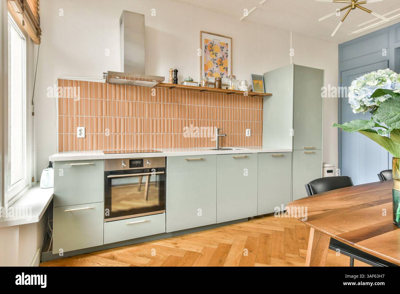 This modern kitchen features a blend of stylish cabinetry, a warm color ...