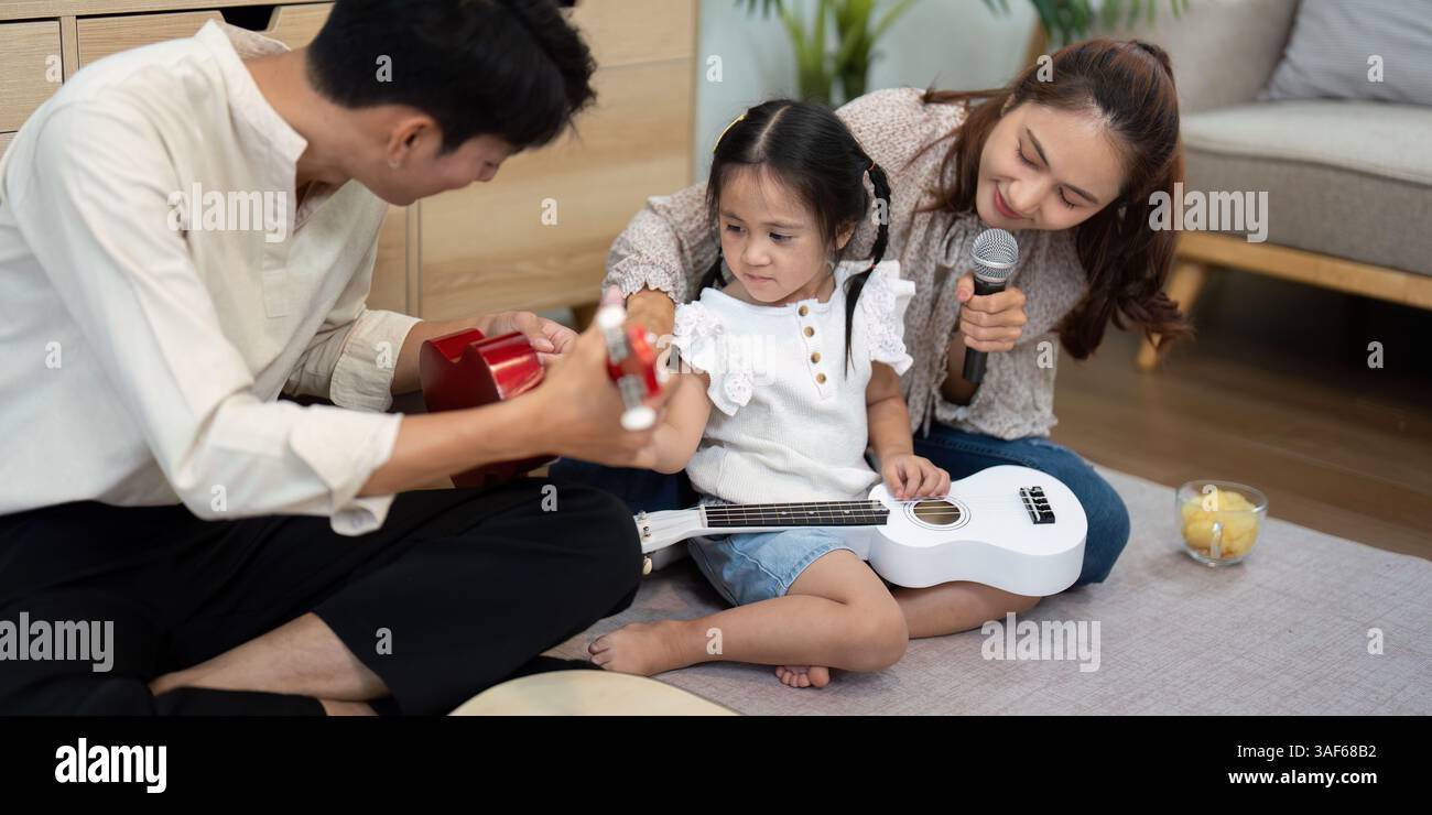 Sharing Music and Laughter. A family engaging in a fun music session ...