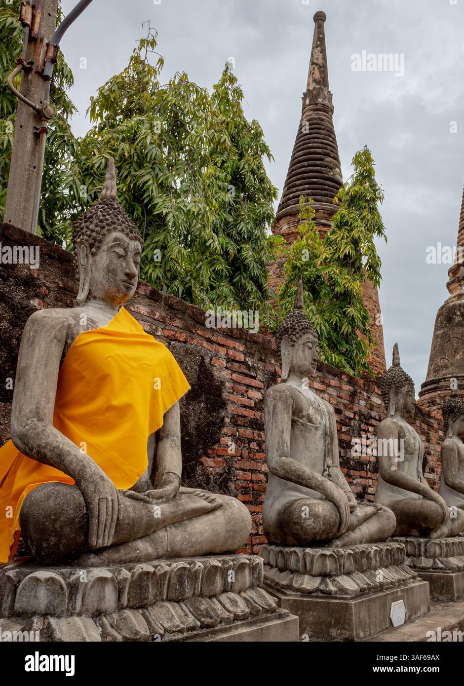 Buddha statues and red brick wall at the stone temple ruin building ...