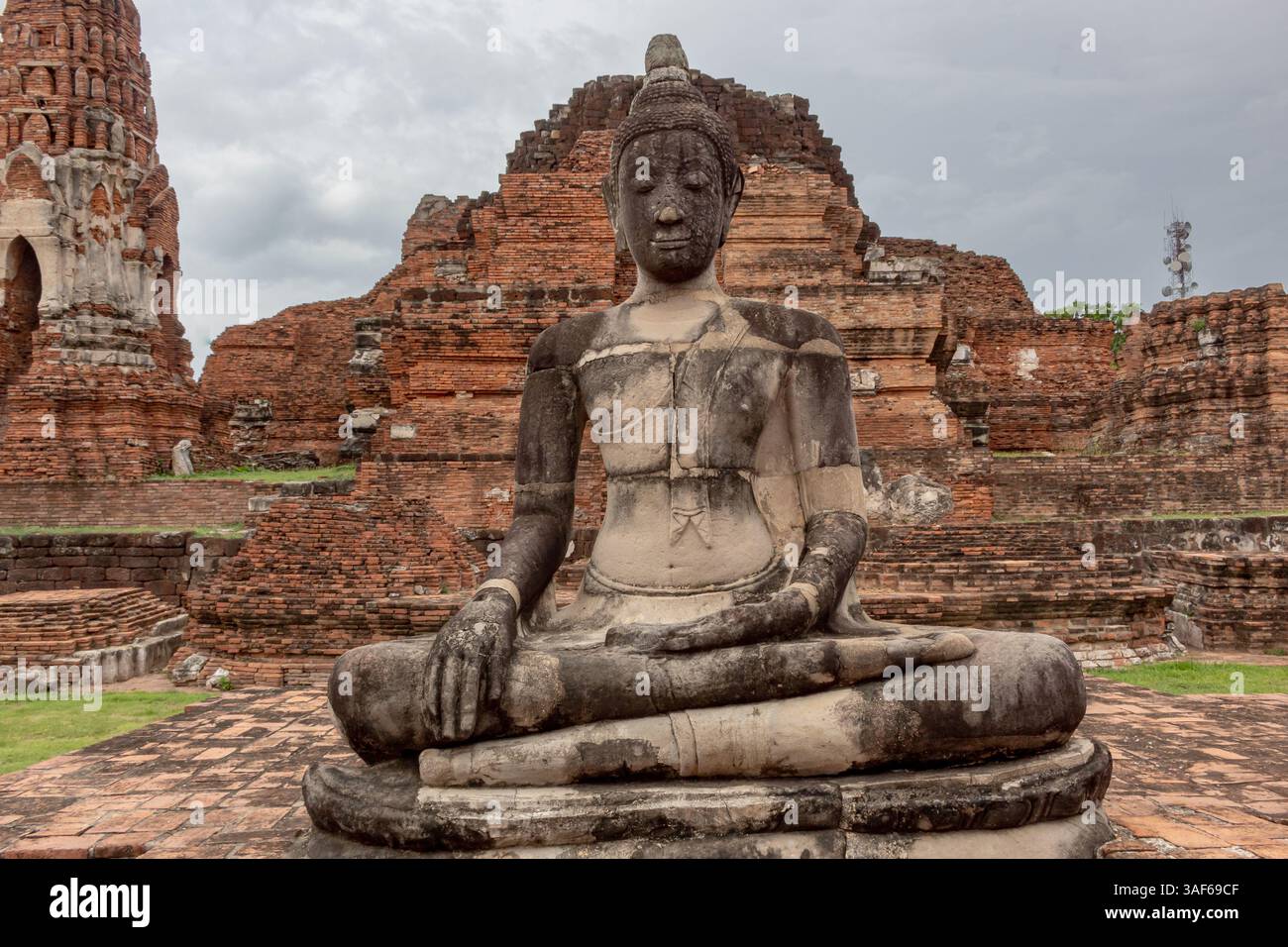 Buddha statues and red brick wall at the stone temple ruin building ...