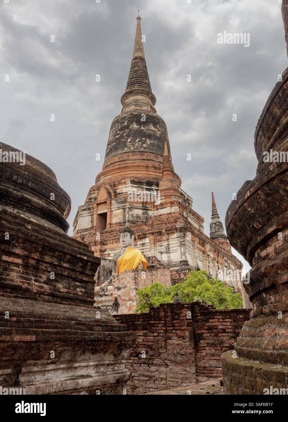Red bricks and stone temple ruin building complex and gold buddha ...