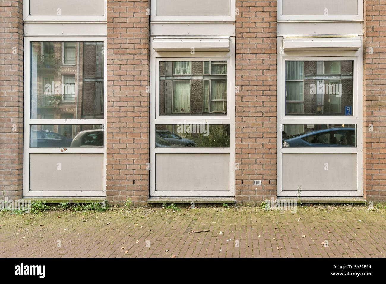 A detailed view of a modern brick building facade featuring multiple ...