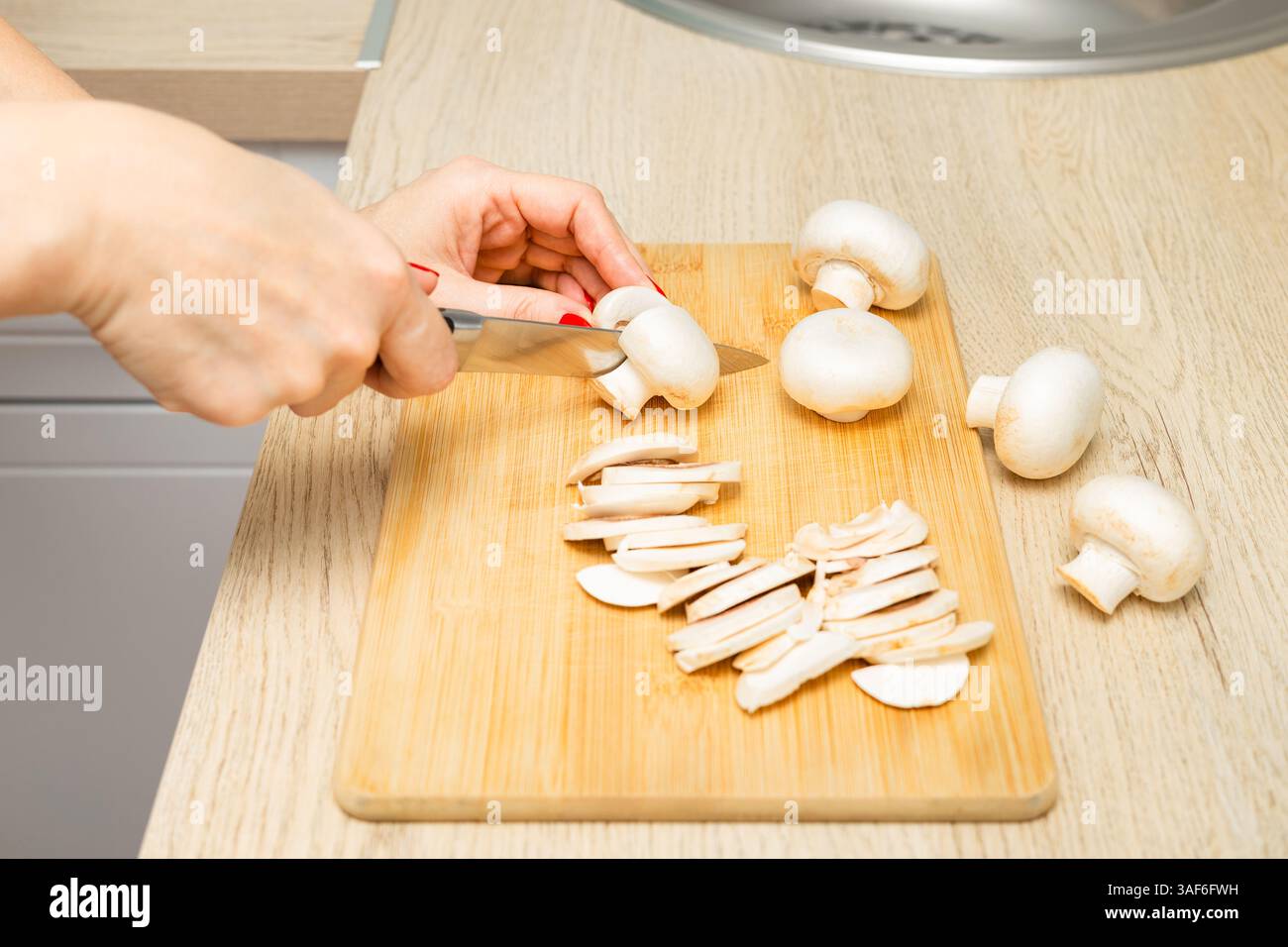 Man cuts mushrooms champignon in hi-res stock photography and images ...