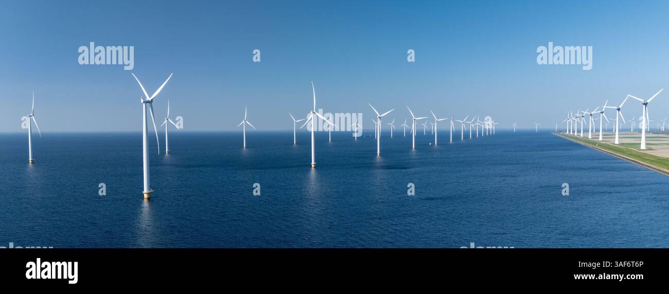 Vast offshore windmill park features numerous turbines harnessing wind energy in the North Sea ...