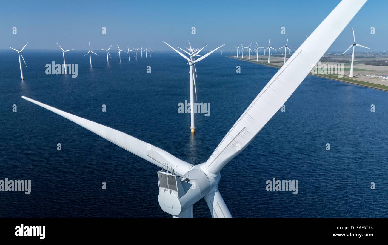 Offshore windmill park featuring numerous turbines that harness wind energy over the vast Dutch ...